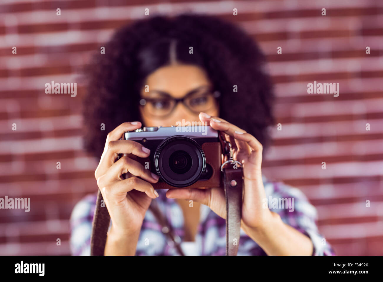 Attractive hipster taking pictures with camera Stock Photo - Alamy