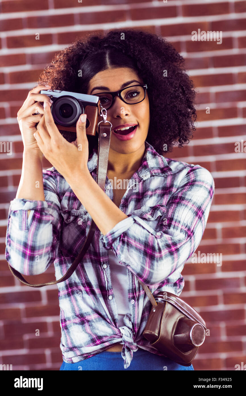 Attractive hipster photographing with camera Stock Photo - Alamy