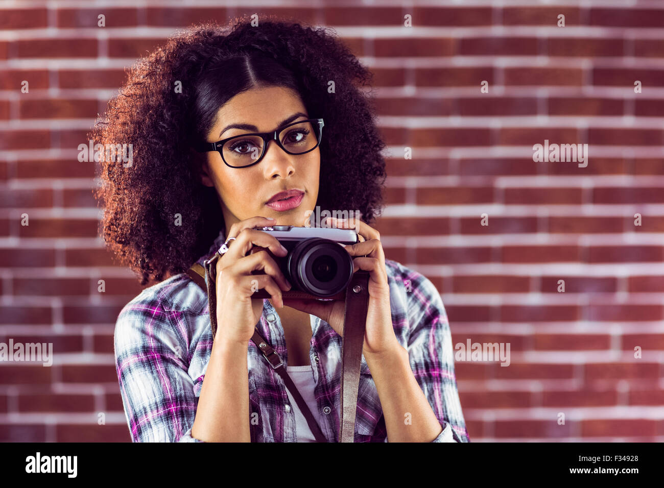 Attractive hipster holding camera Stock Photo - Alamy