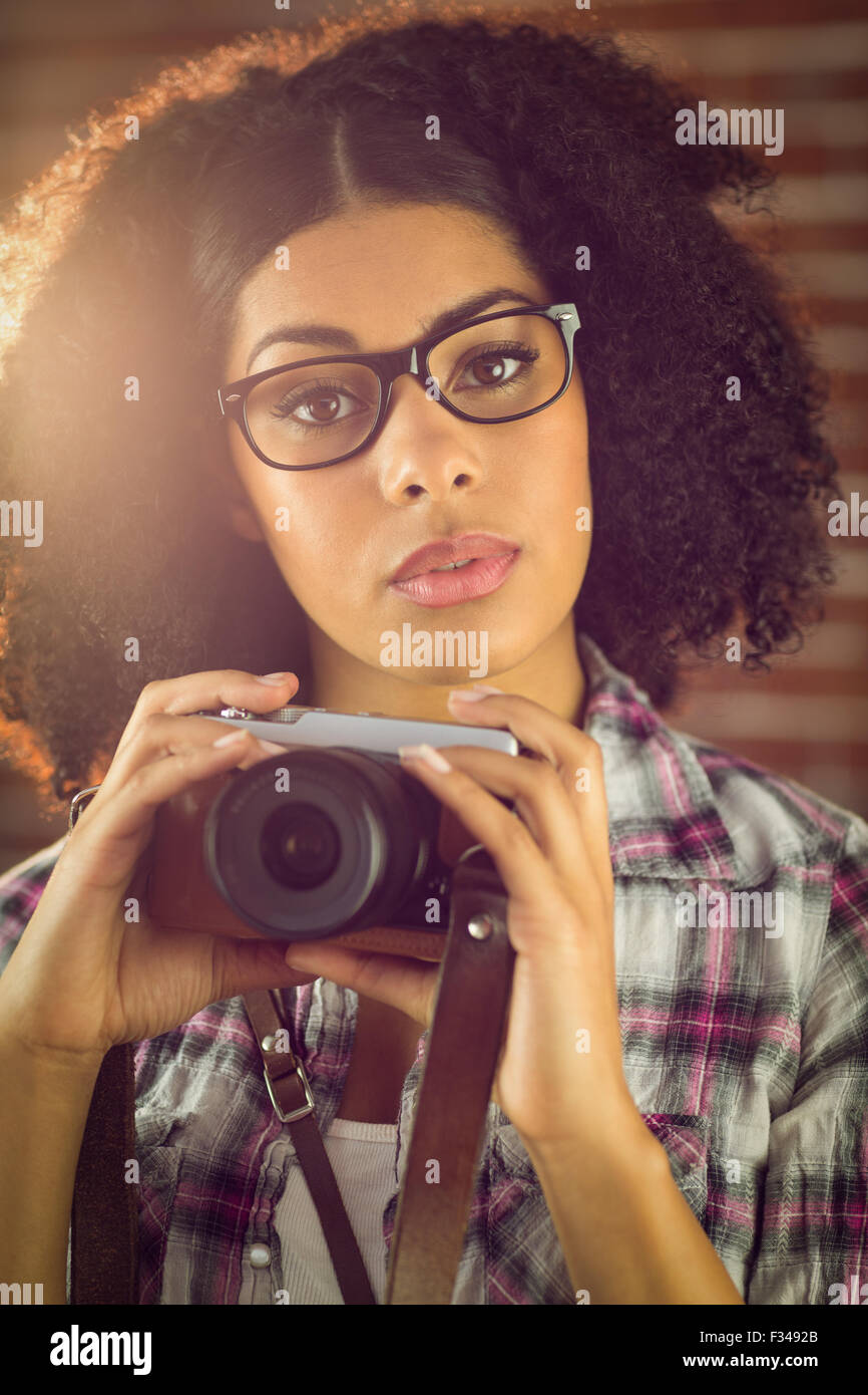 Attractive hipster holding camera Stock Photo - Alamy