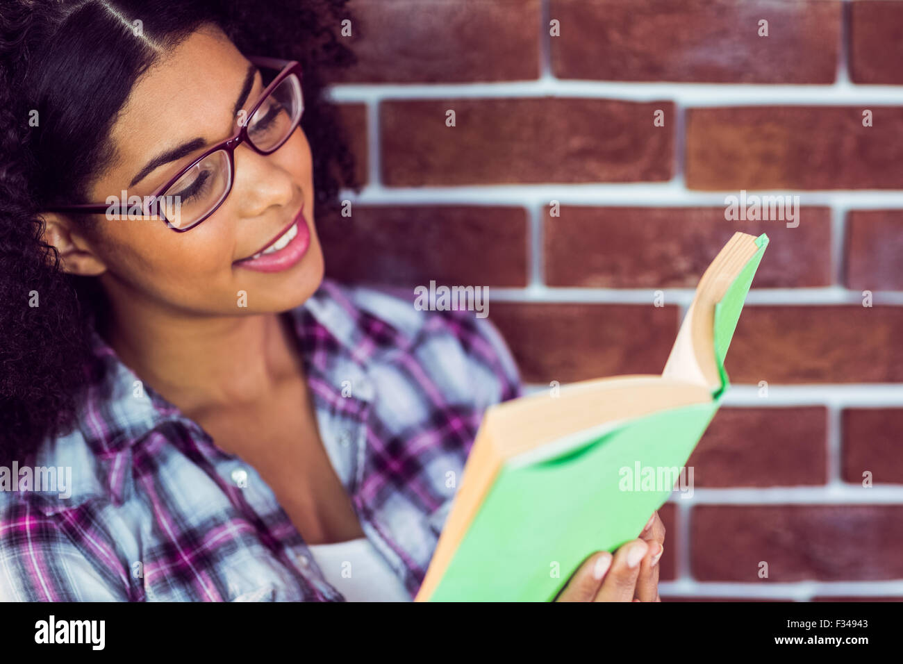 Attractive hipster reading book Stock Photo - Alamy