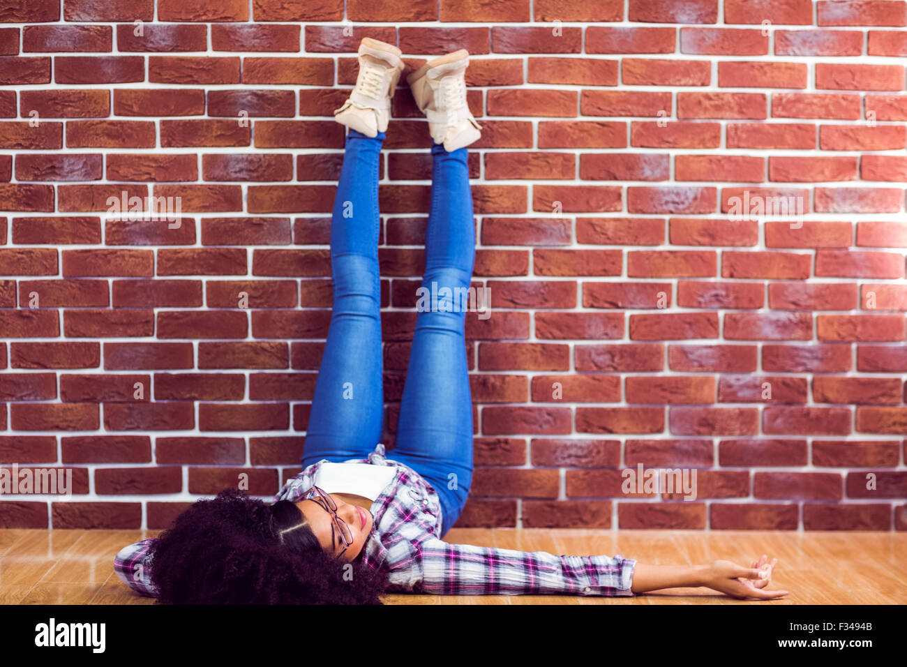 Attractive hipster lying on ground and holding legs up Stock Photo - Alamy