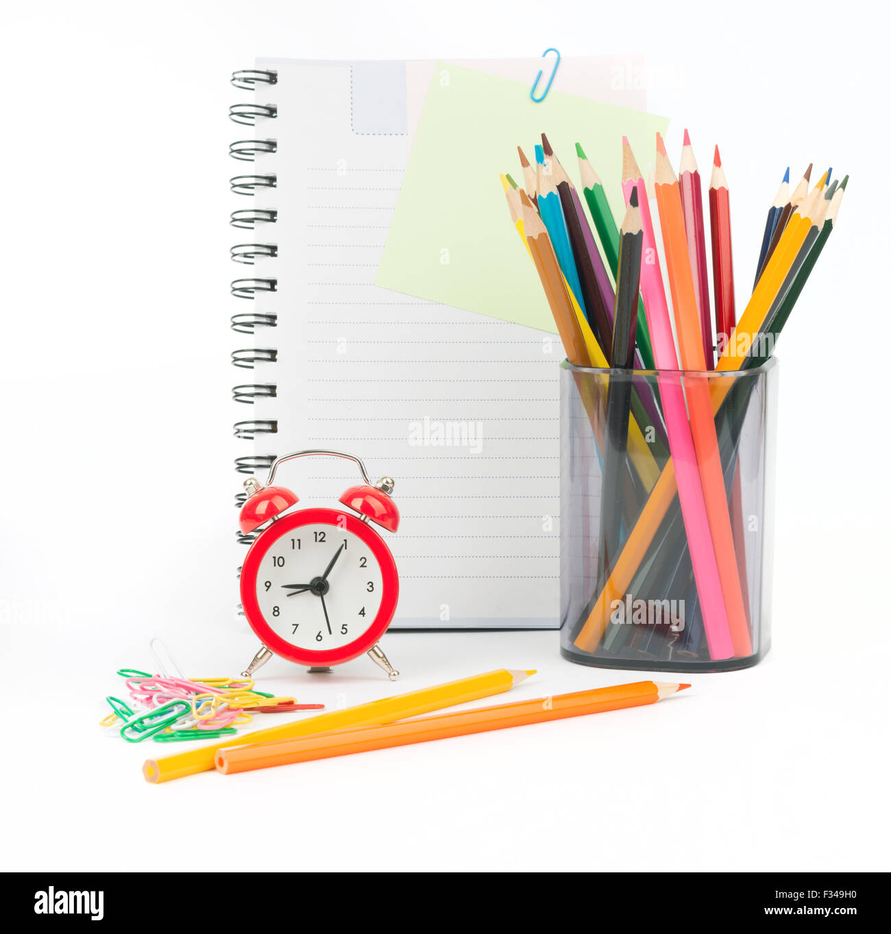 Pencil cup with crayons and notebook Stock Photo - Alamy