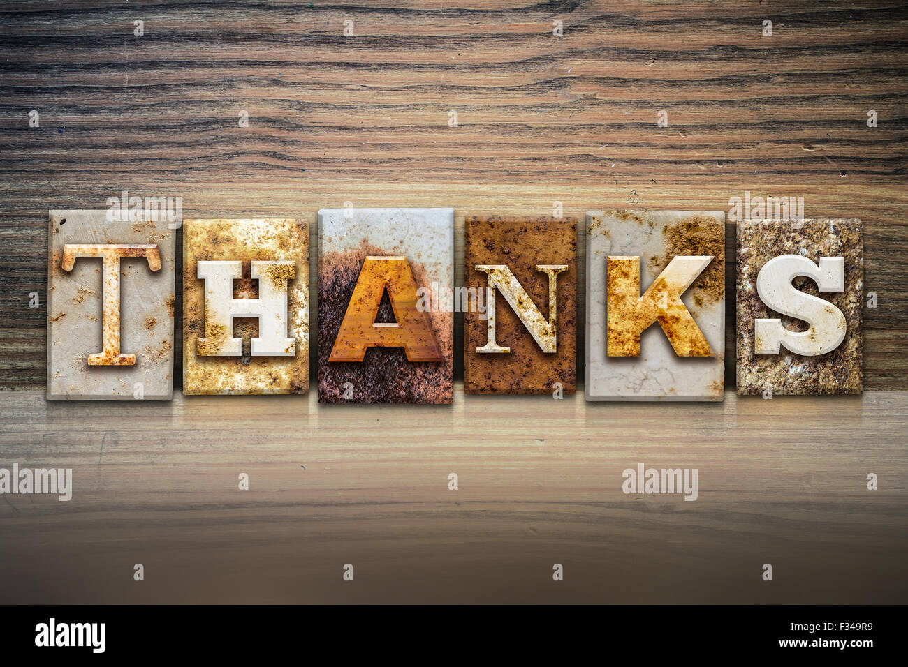 The word "THANKS" written in rusty metal letterpress type sitting on a ...