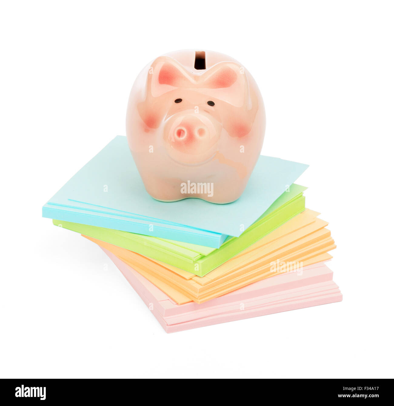 Piggy bank on pile of stickers Stock Photo - Alamy
