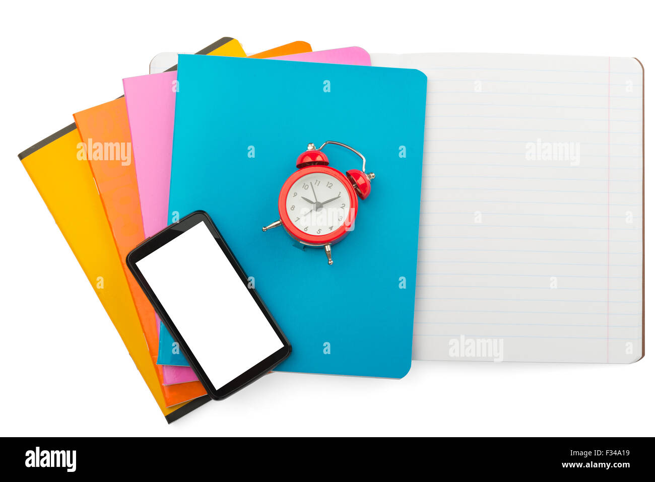 Notebooks and alarm clock Stock Photo - Alamy