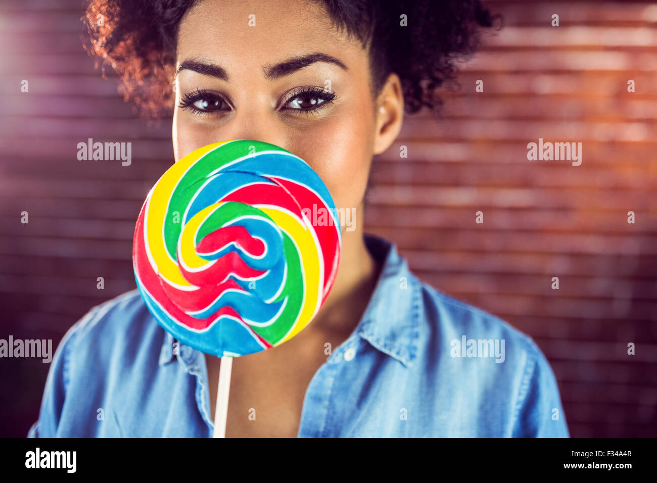 A beautiful woman holding a giant lollipop Stock Photo - Alamy