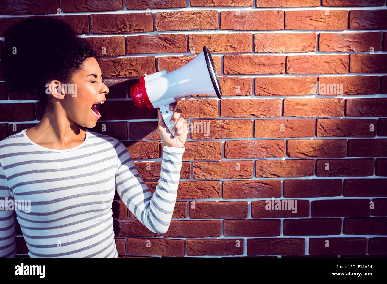Young woman using her megaphone in the light Stock Photo - Alamy