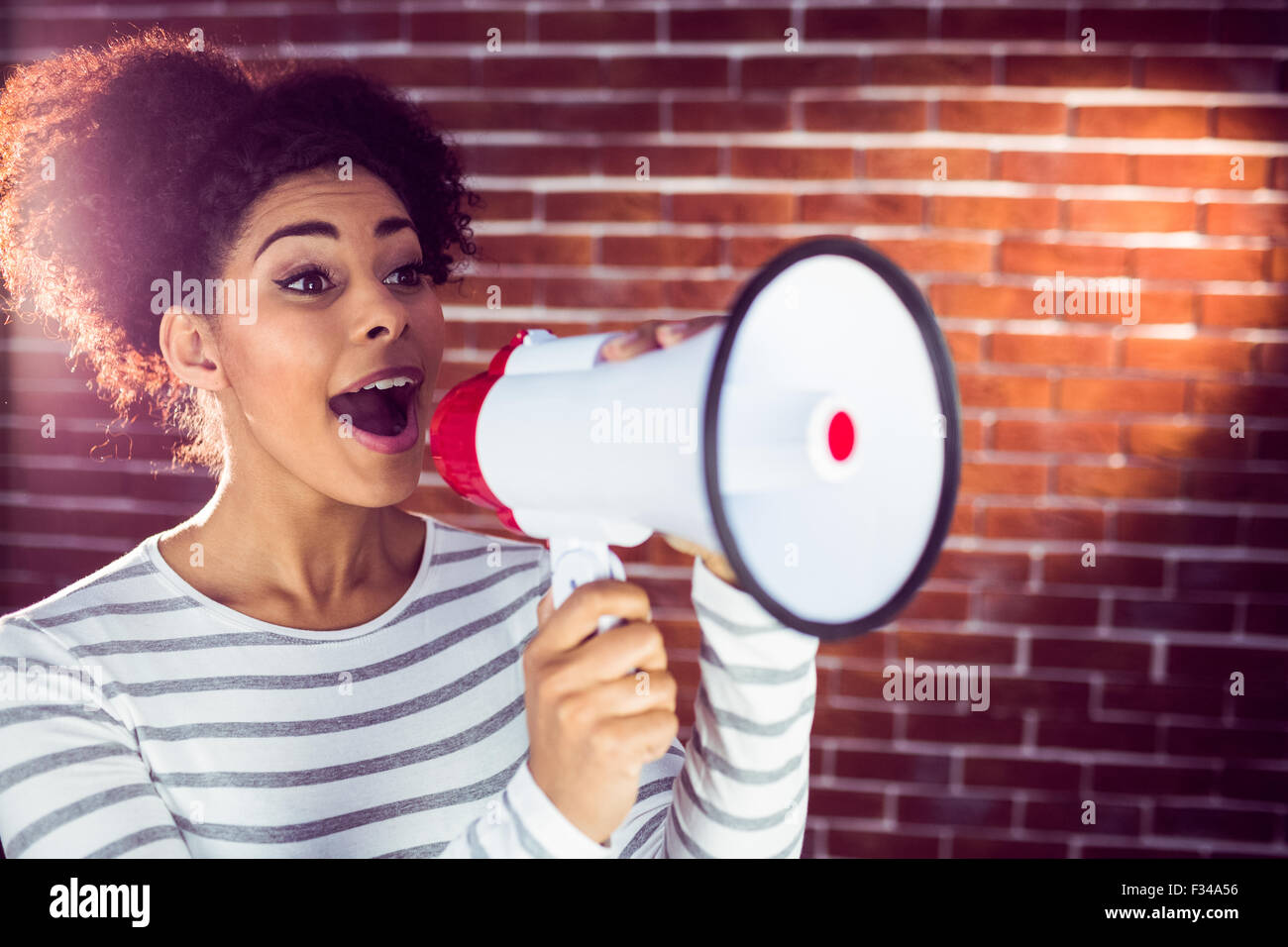 Young woman using her megaphone in the light Stock Photo - Alamy