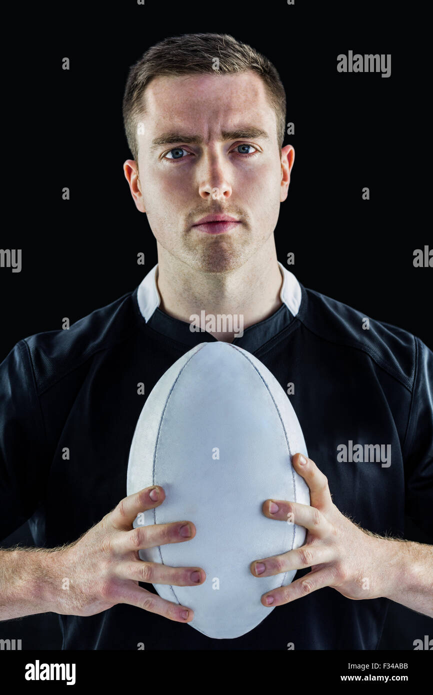 Rugby player holding a rugby ball Stock Photo - Alamy