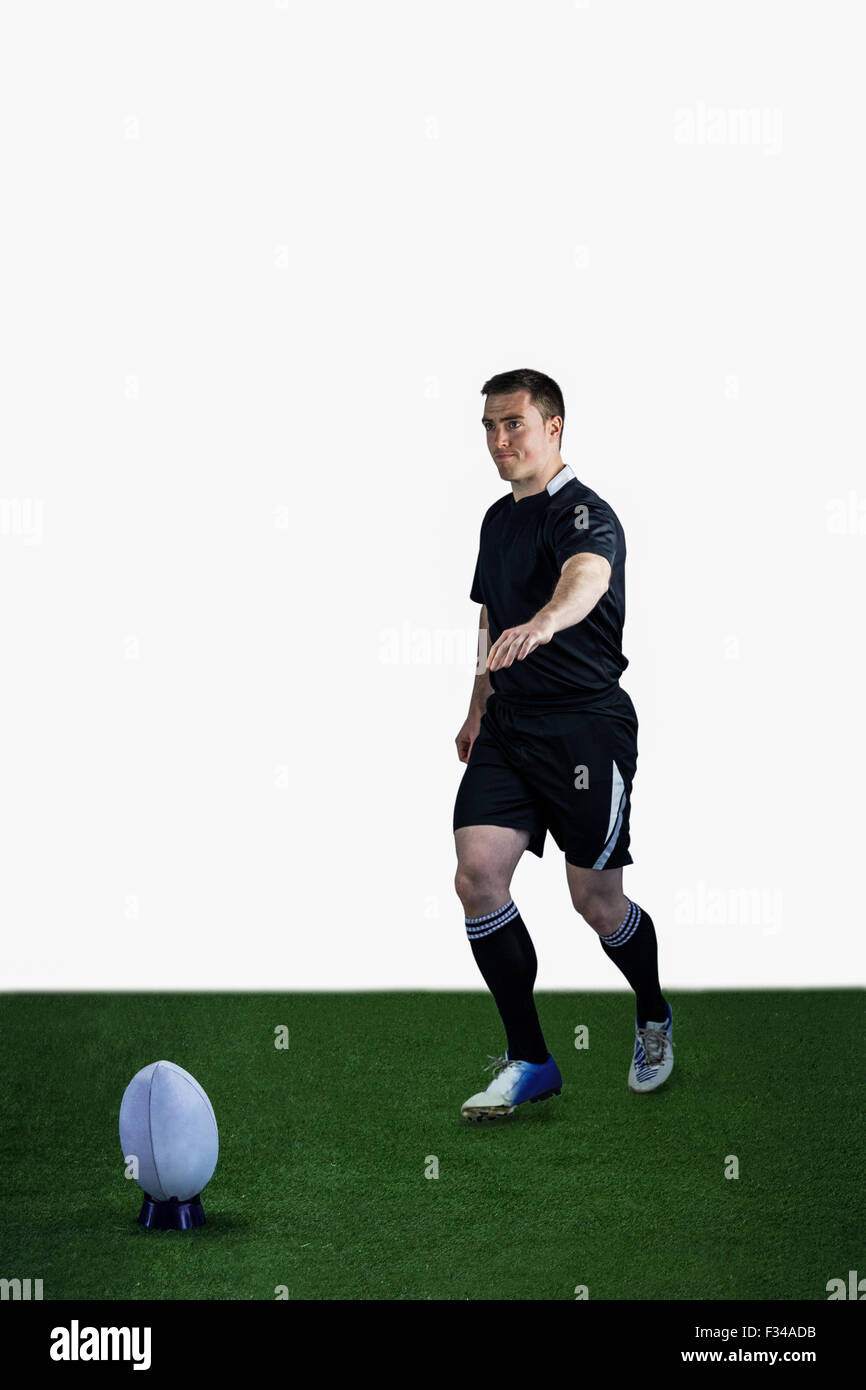 Rugby player doing a drop kick Stock Photo - Alamy