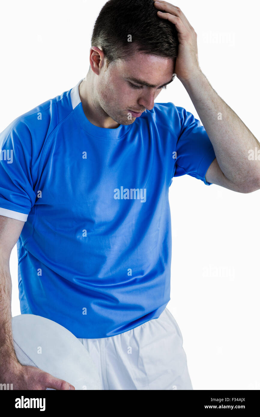 Disappointed rugby player holding his head Stock Photo - Alamy
