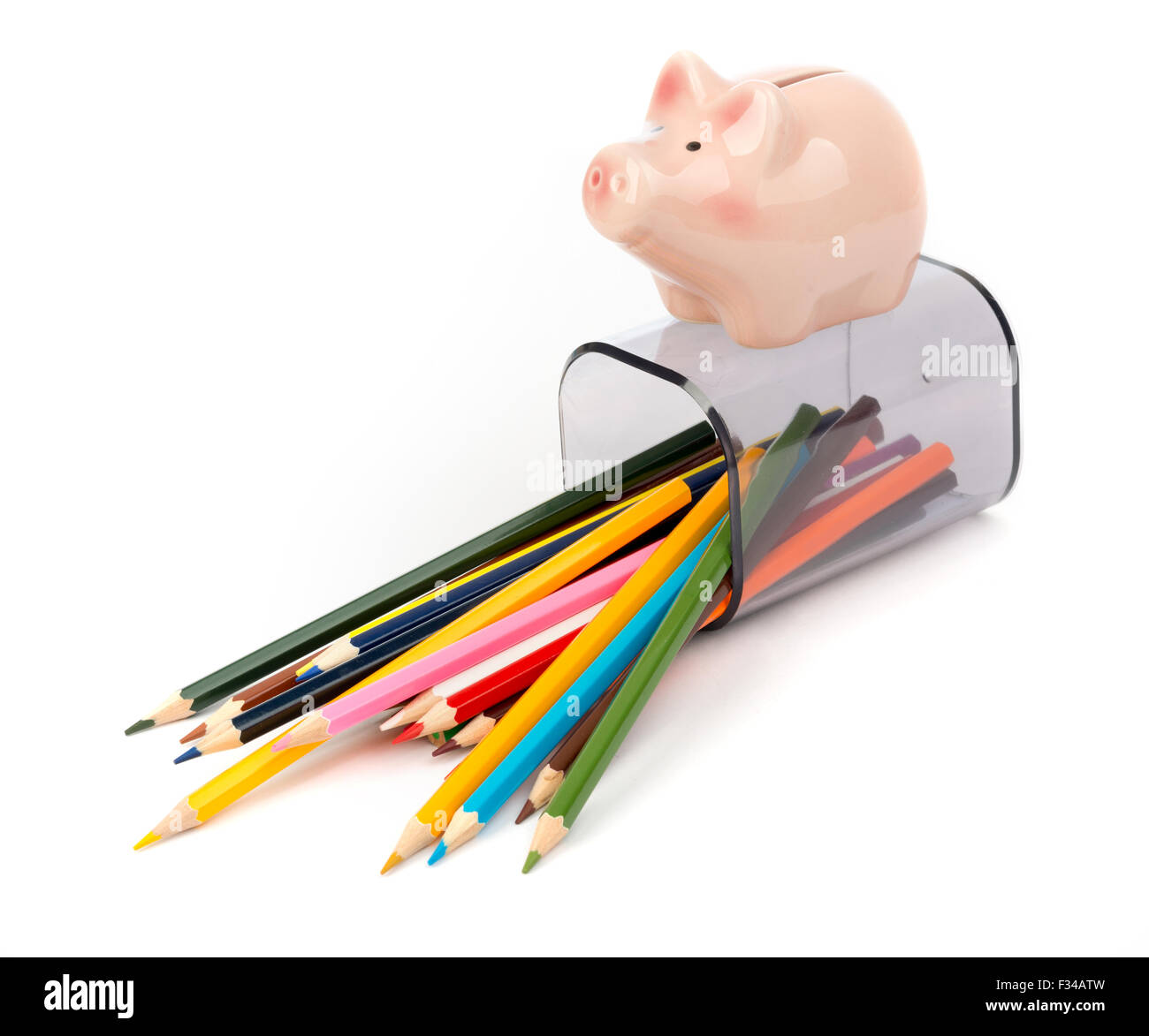 Fallen pencil cup with crayons and piggy bank Stock Photo - Alamy