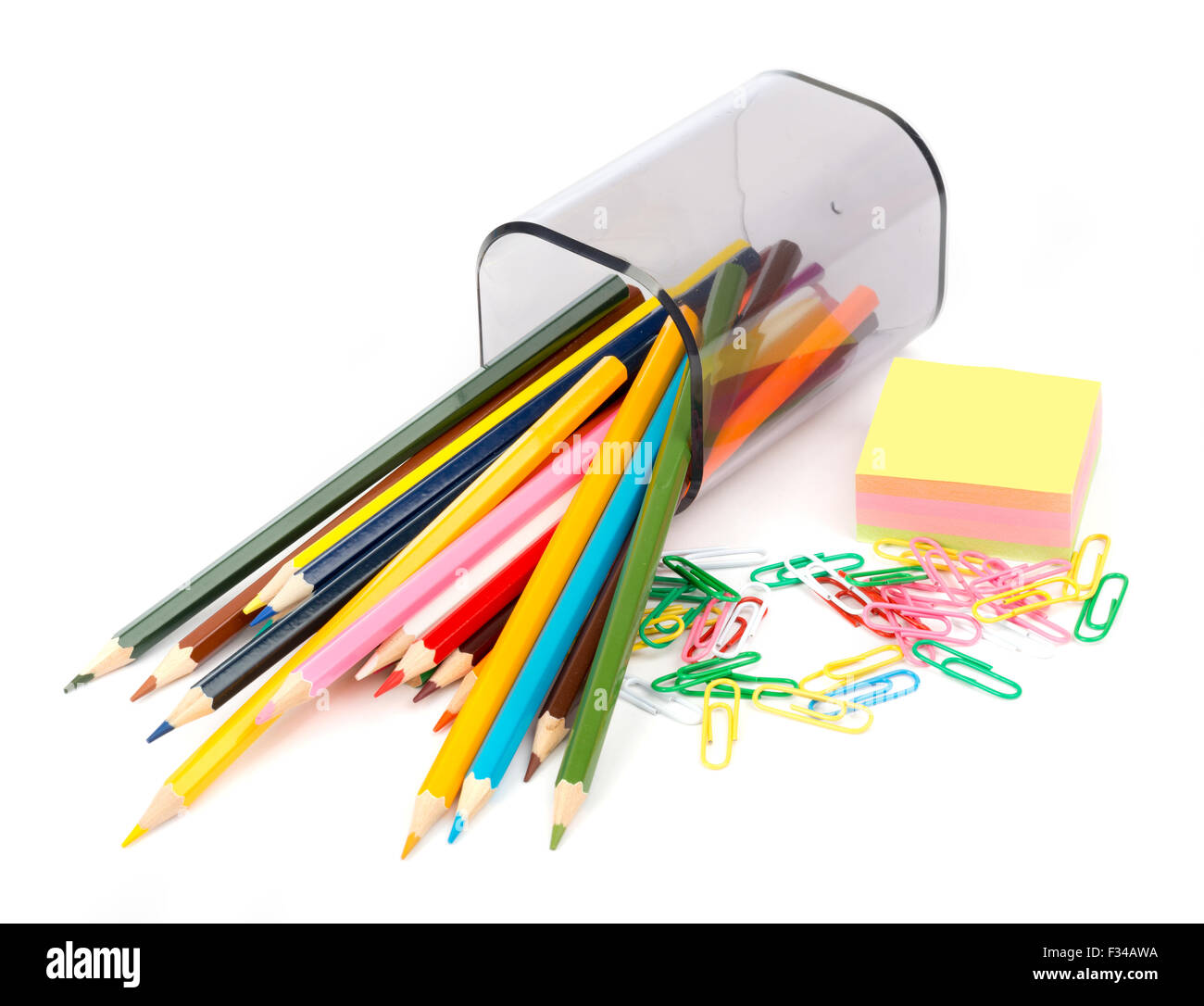Fallen pencil cup with crayons and stickers Stock Photo - Alamy