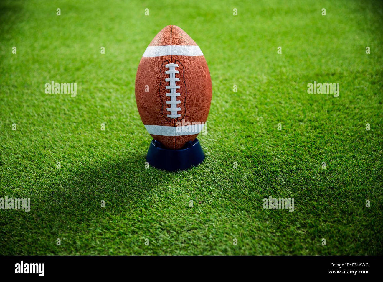 American football standing on holder Stock Photo - Alamy