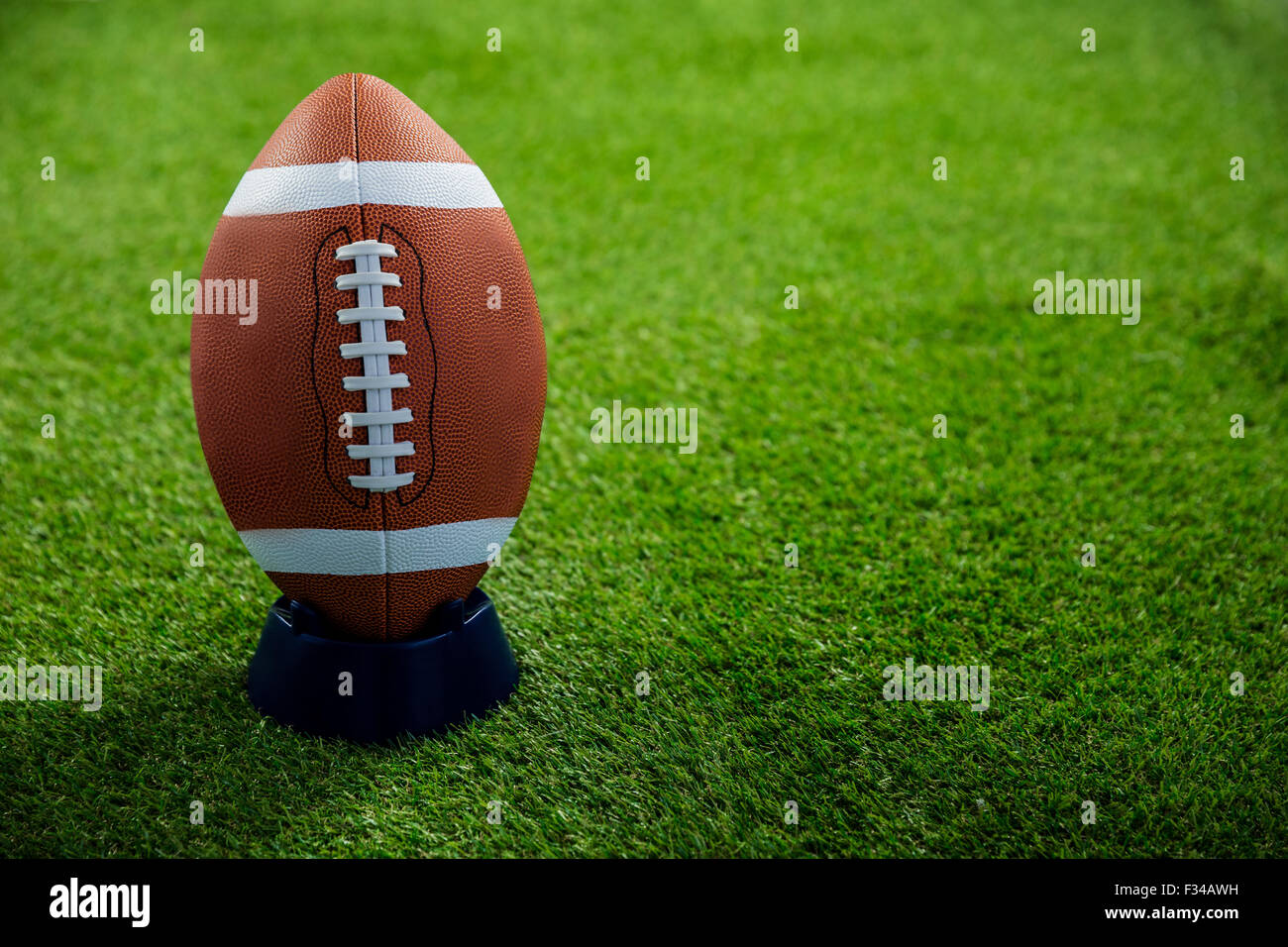 American football standing on holder Stock Photo - Alamy