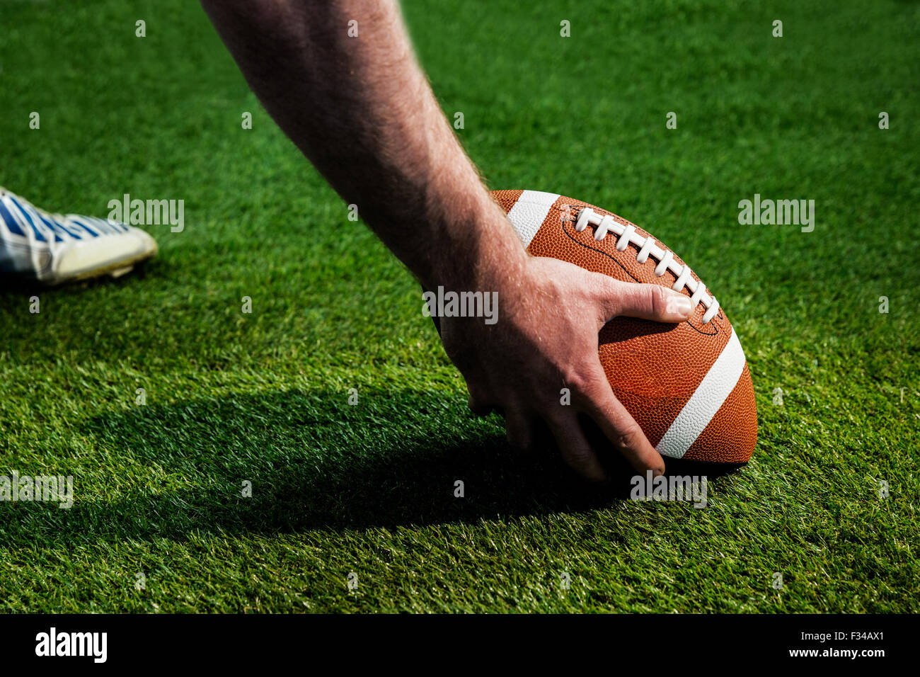 American football player preparing for a drop kick Stock Photo - Alamy