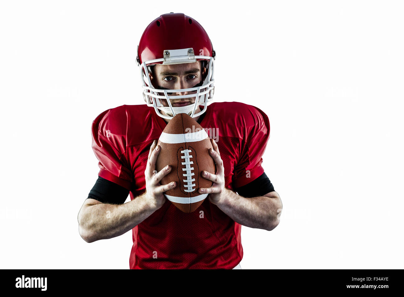 Portrait of focused american football player holding football Stock ...