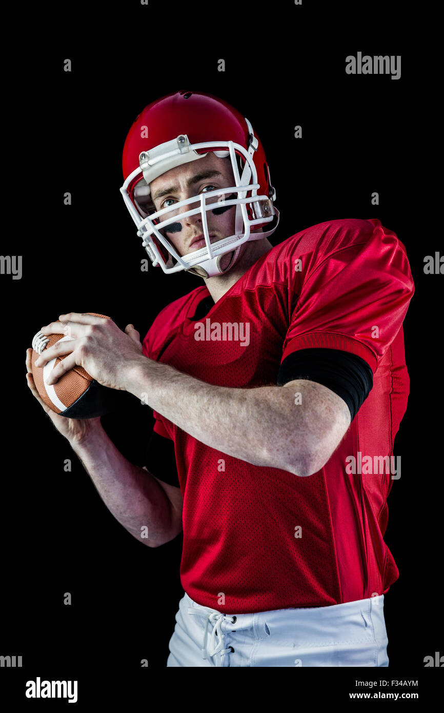 Portrait of american football player being about to throw football ...