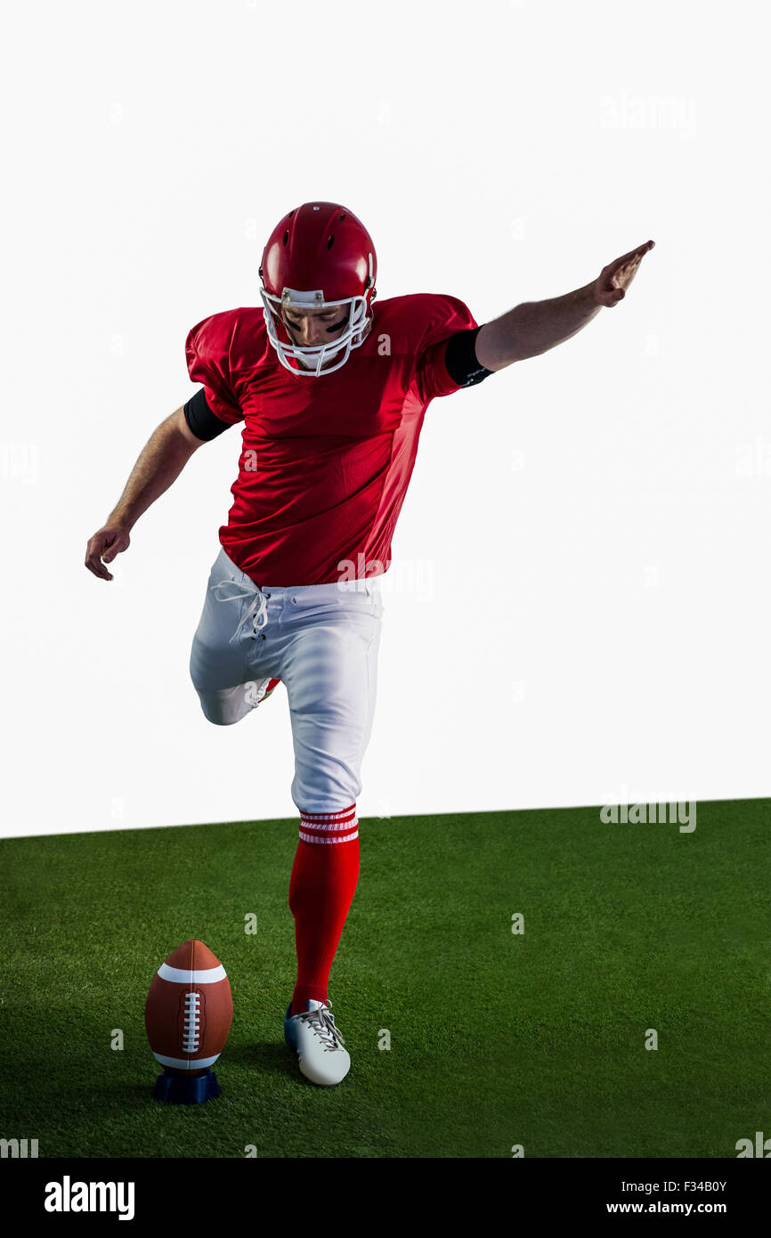 American football player kicking football Stock Photo - Alamy