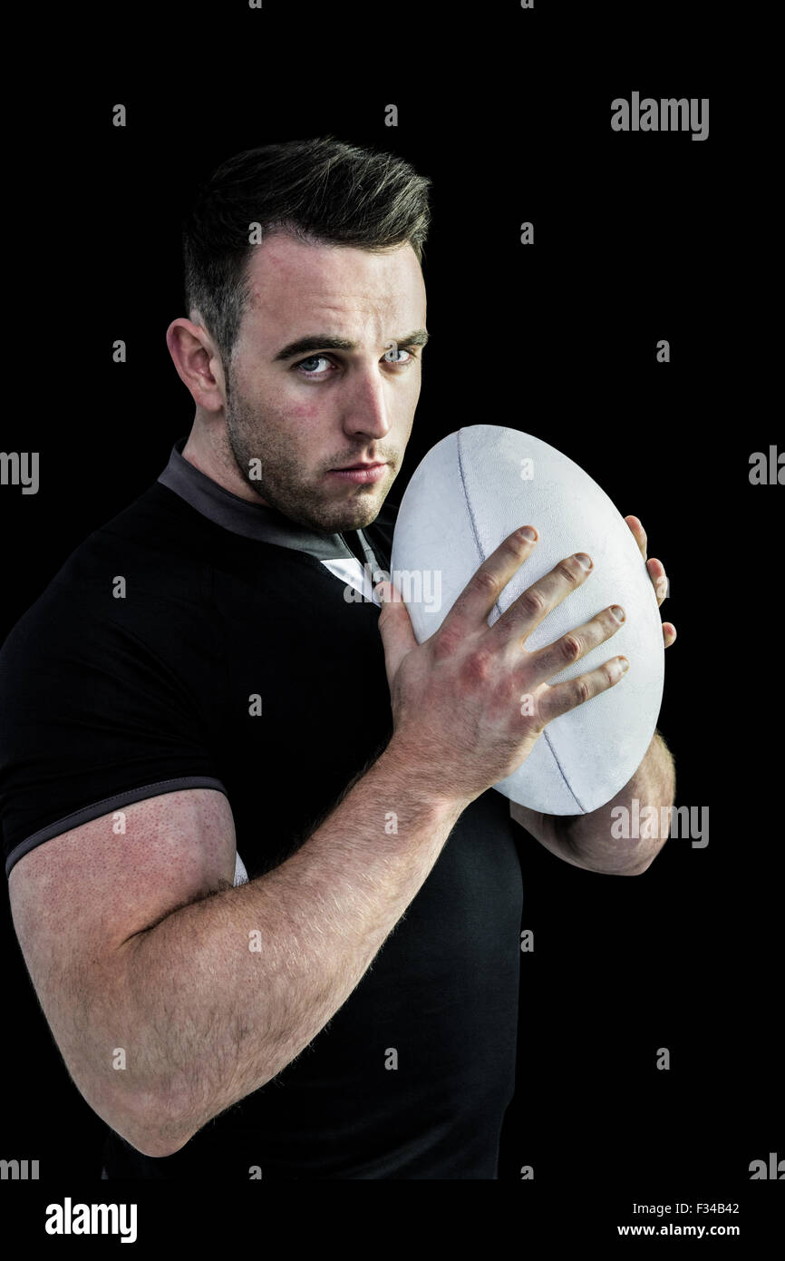 Tough rugby player holding ball Stock Photo - Alamy