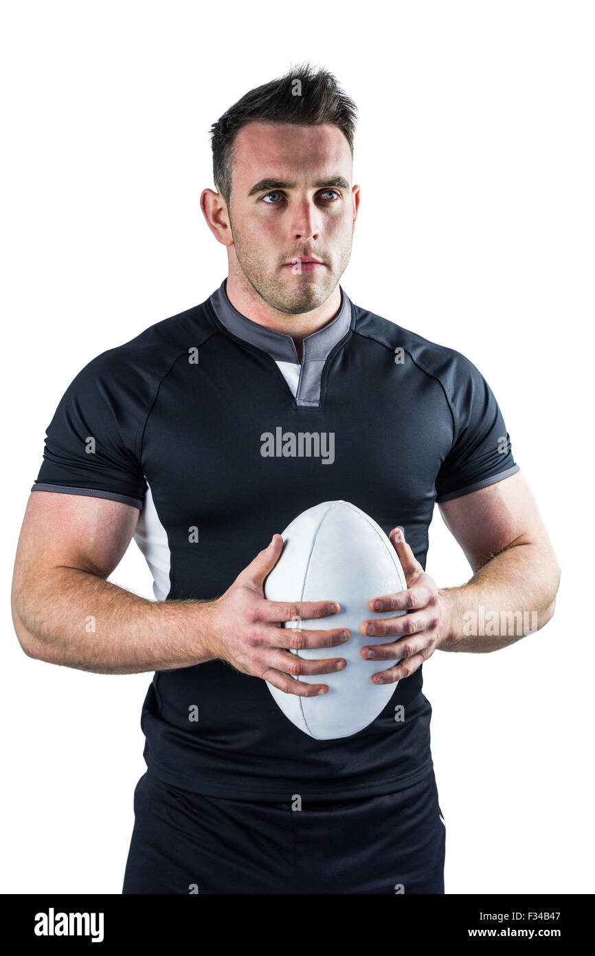 Tough rugby player holding ball Stock Photo - Alamy