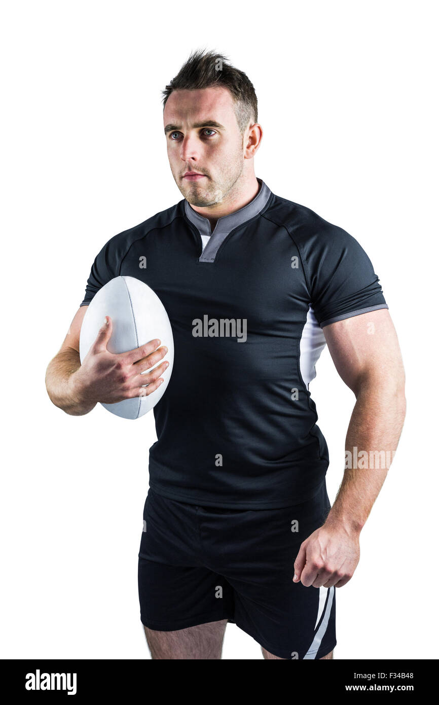 Tough rugby player holding ball Stock Photo - Alamy