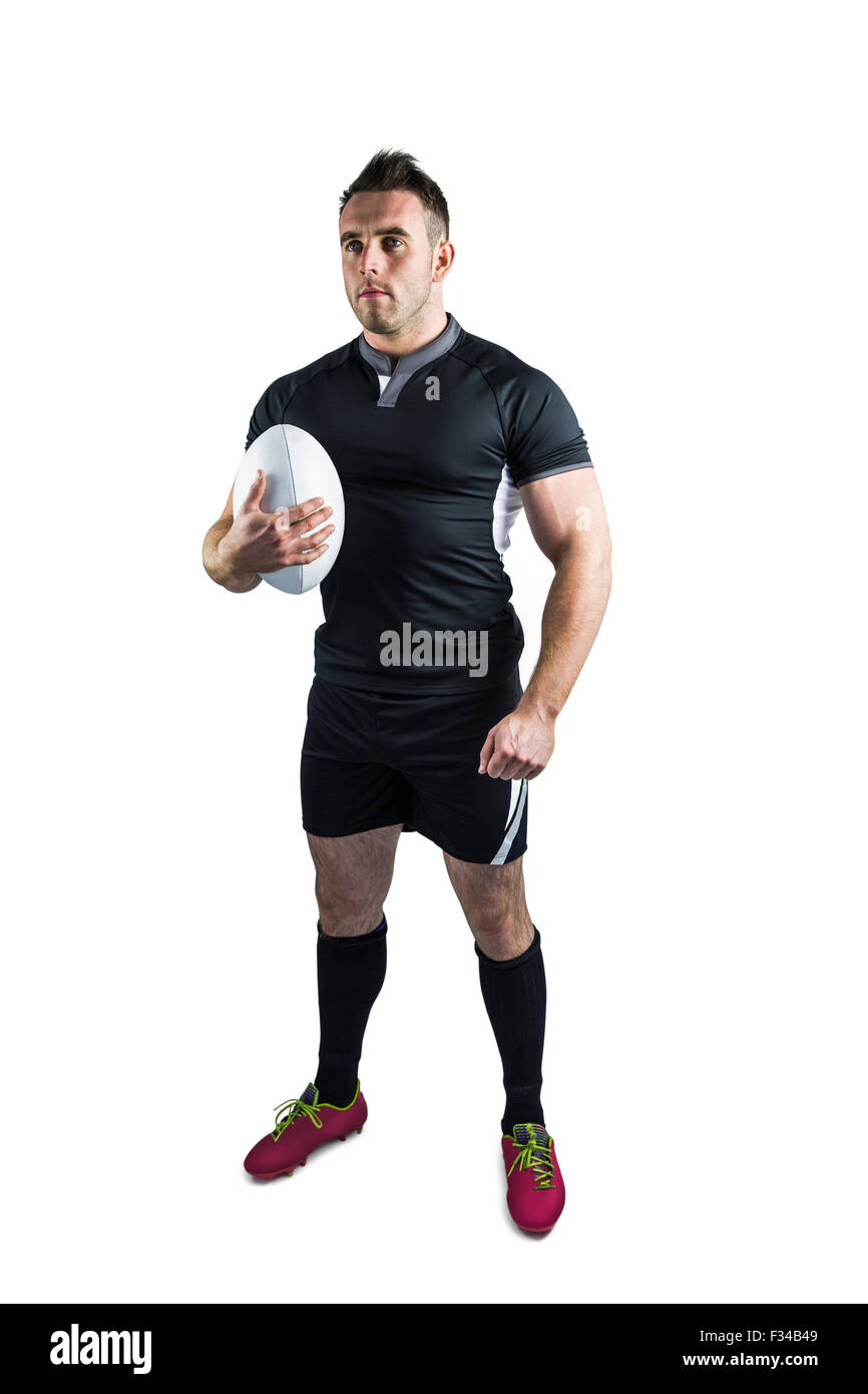 Tough rugby player holding ball Stock Photo - Alamy