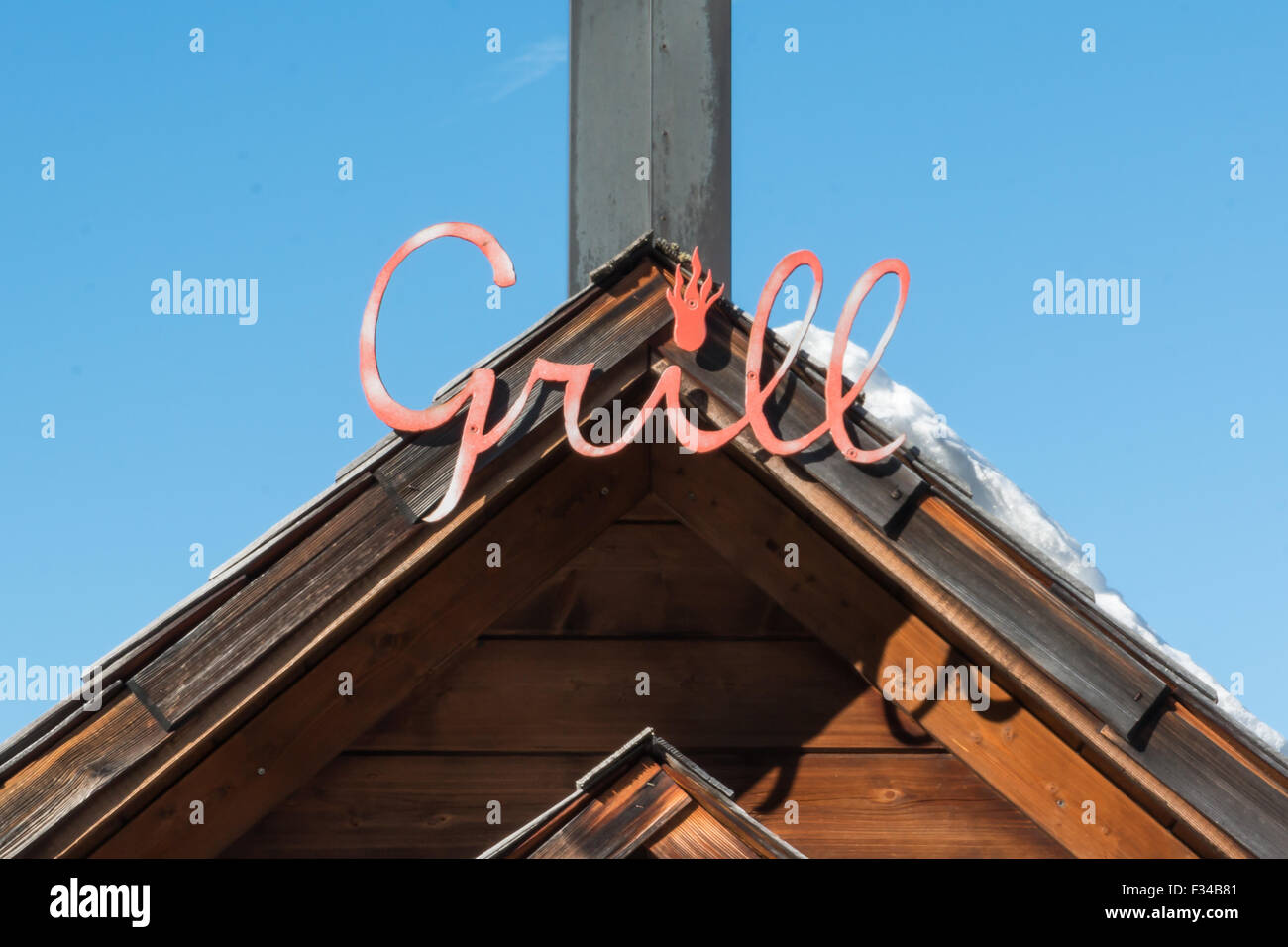 red grill sign on wodden sloping roof covered with snow Stock Photo - Alamy