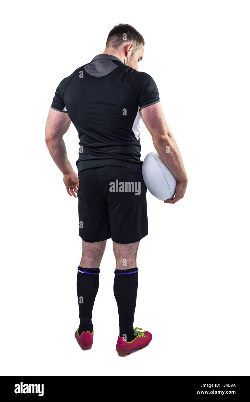 Tough rugby player holding ball Stock Photo - Alamy