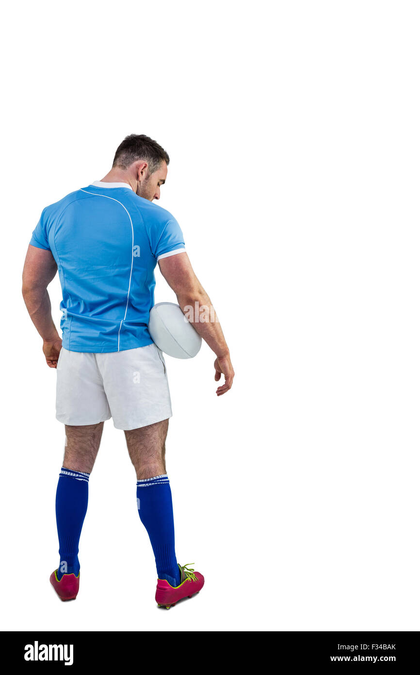 Rugby player standing with ball Stock Photo - Alamy