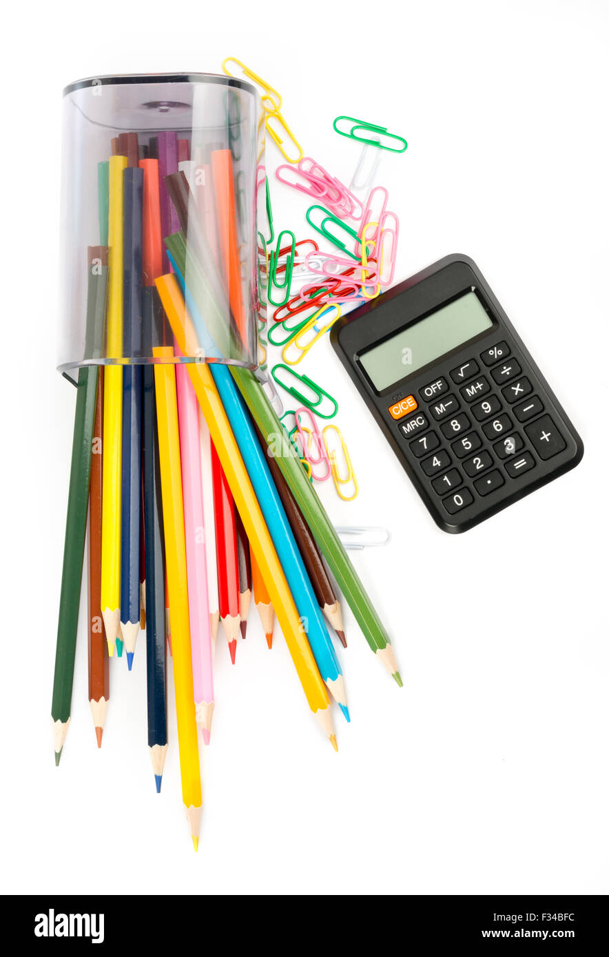 Fallen pencil cup with crayons and calculator Stock Photo - Alamy