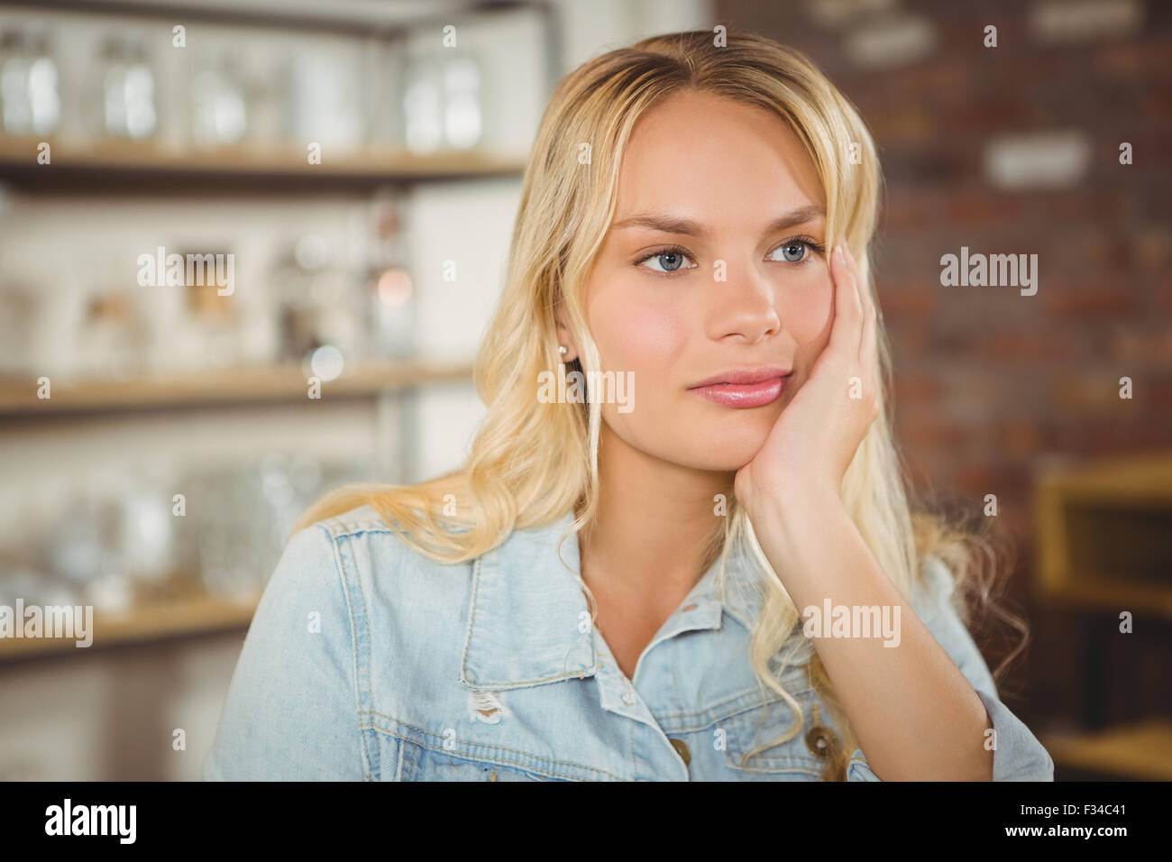 Pretty blonde daydreaming Stock Photo - Alamy