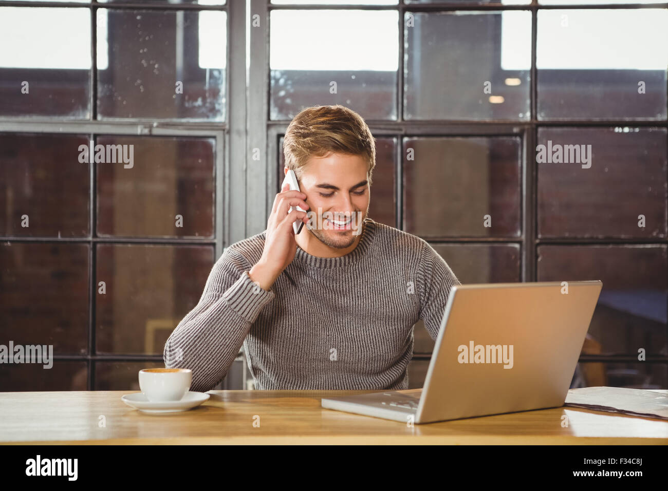 Handsome man smiling and phoning with smartphone Stock Photo - Alamy