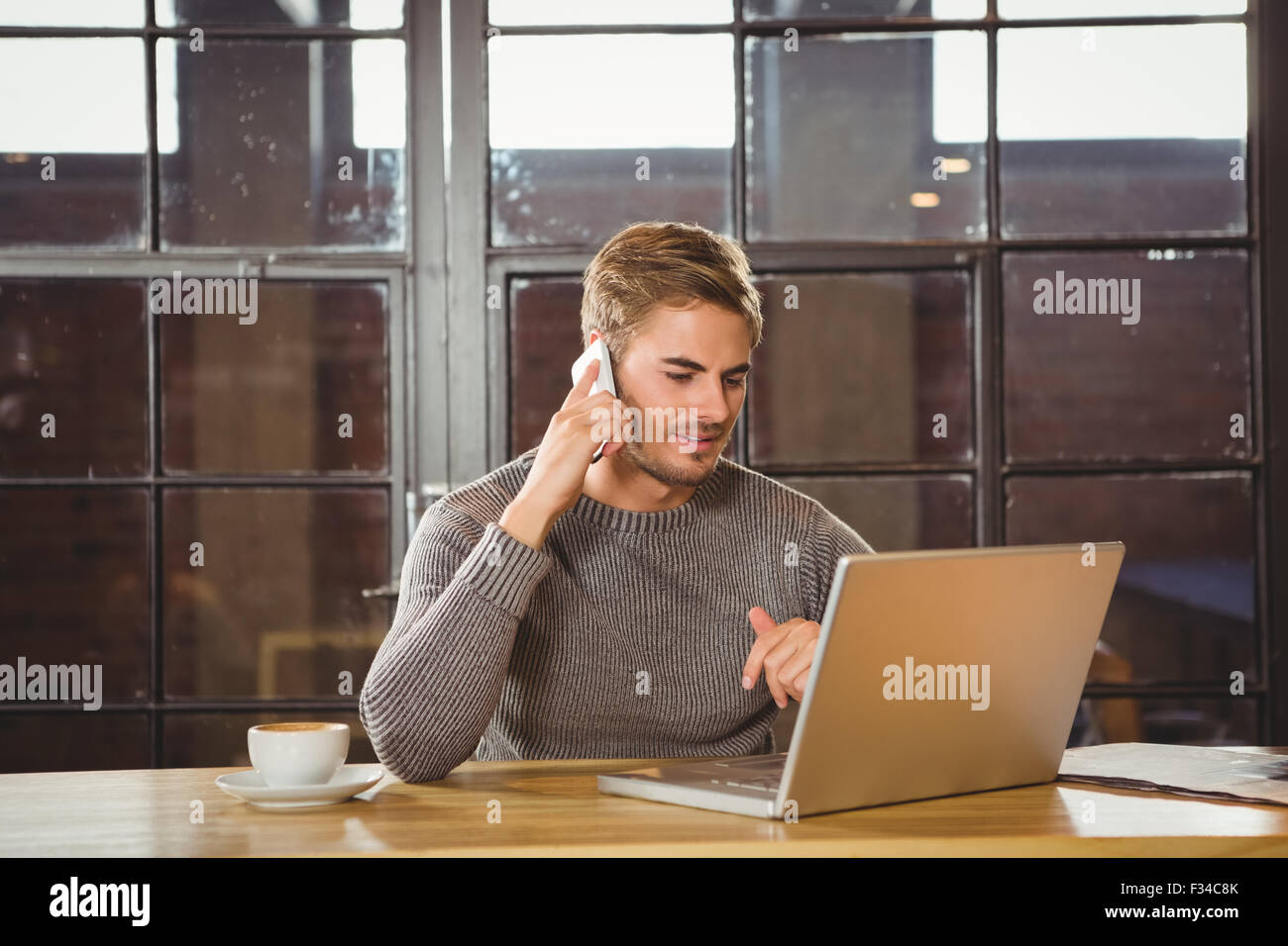 Handsome man looking laptop hi-res stock photography and images - Alamy