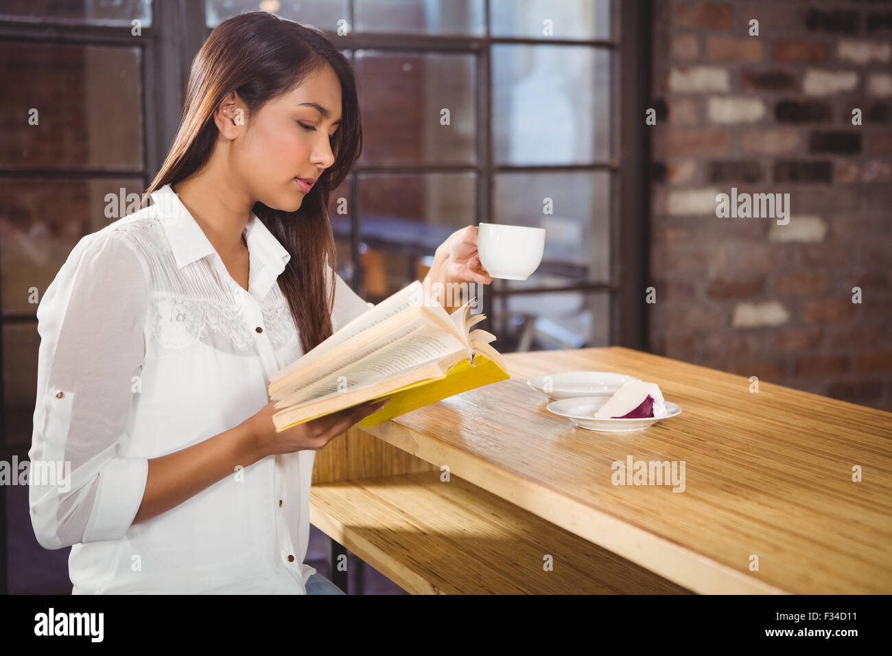 Beautiful businesswoman reading a book Stock Photo - Alamy