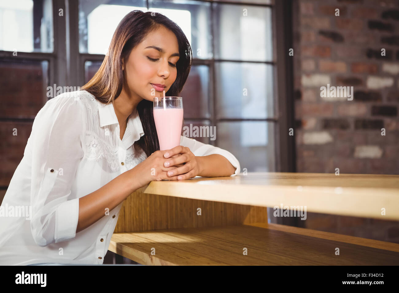 Beautiful woman drinking pink milkshake hi-res stock photography and ...