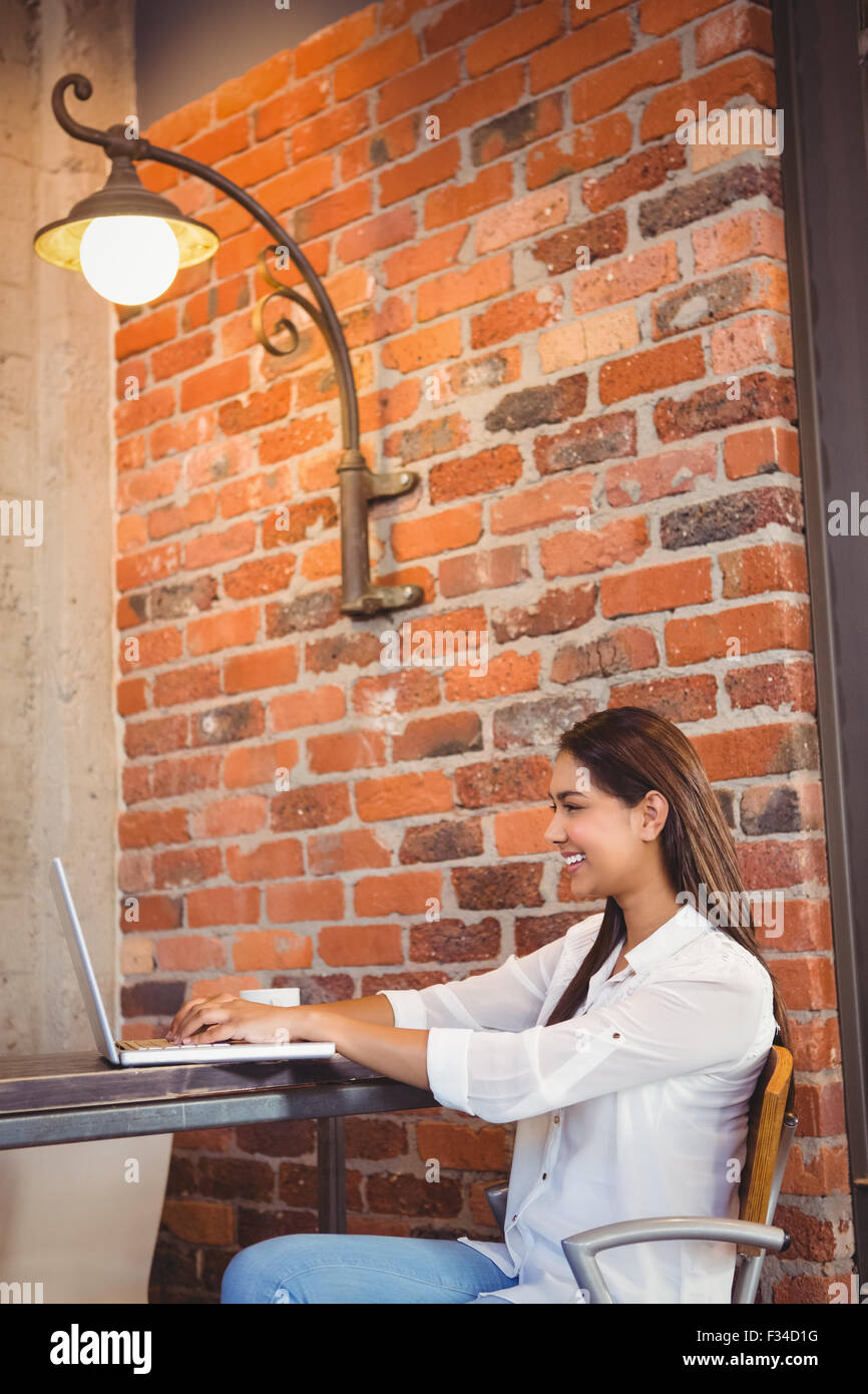 Businesswoman having coffee and working on laptop Stock Photo - Alamy
