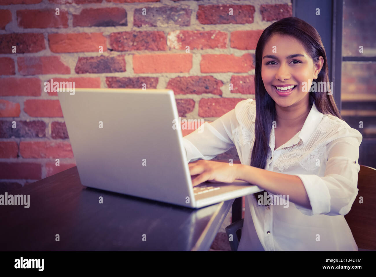 Businesswoman having coffee and working on laptop Stock Photo - Alamy