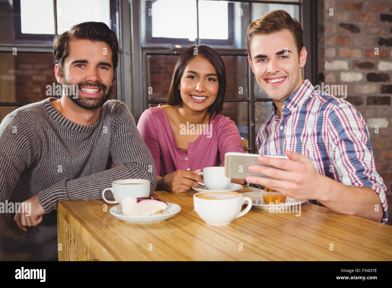 Group of friends looking at a smartphone Stock Photo - Alamy