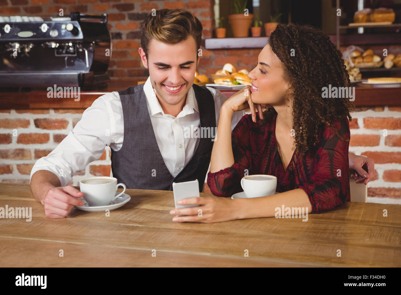Cute couple having coffee together Stock Photo - Alamy