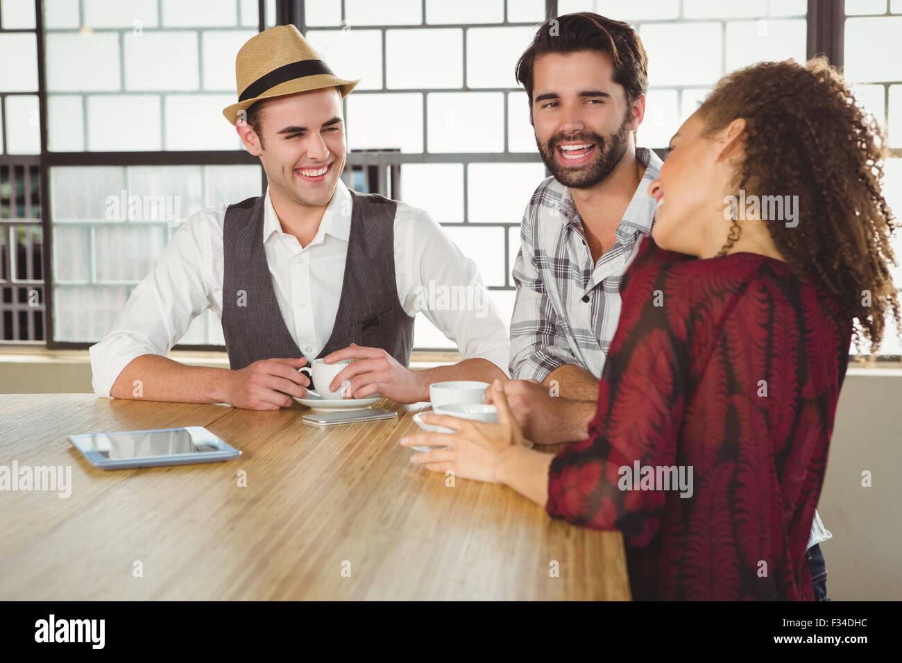 Happy friends discussing together Stock Photo - Alamy