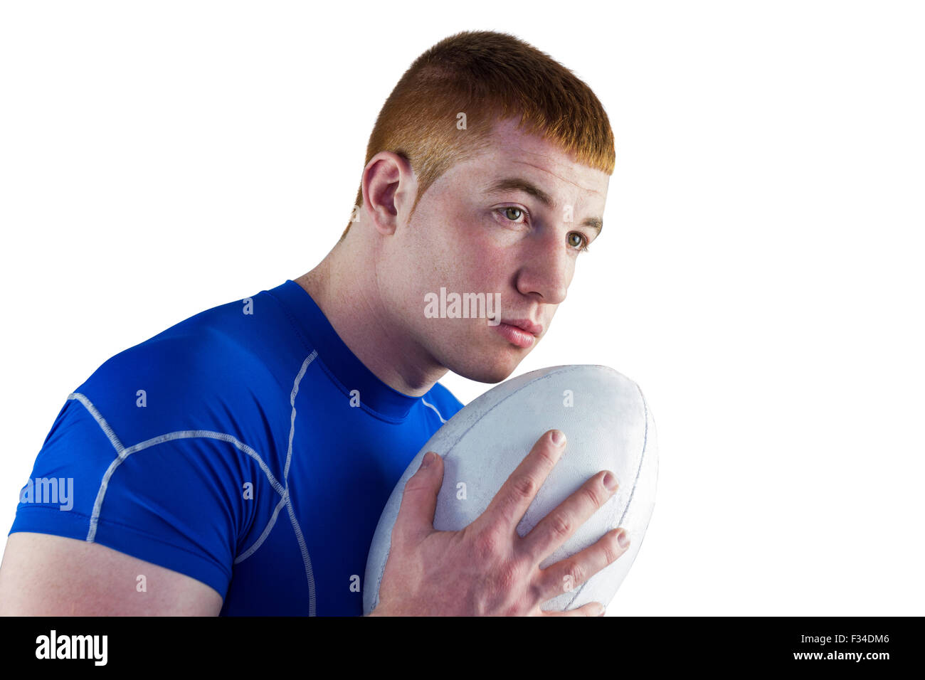 Rugby player holding rugby ball Stock Photo - Alamy