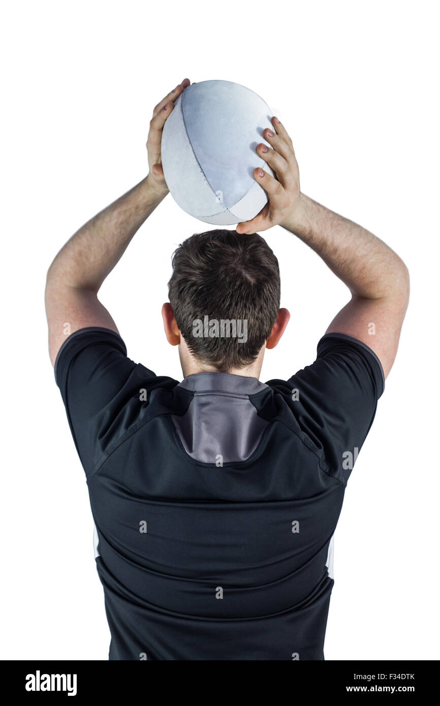 Back turned rugby player throwing a ball Stock Photo - Alamy