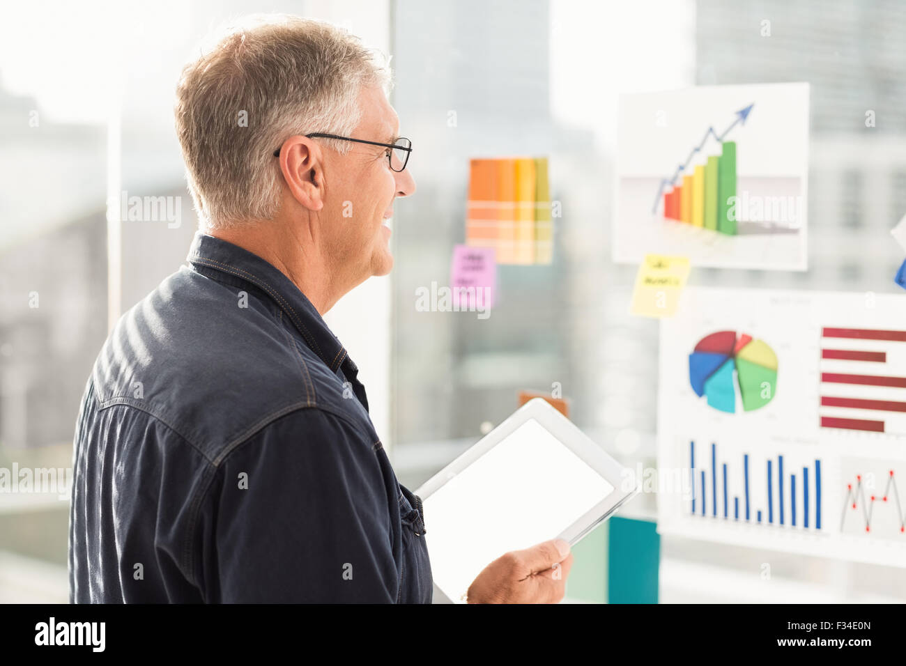 Businessman looking at charts hi-res stock photography and images - Alamy