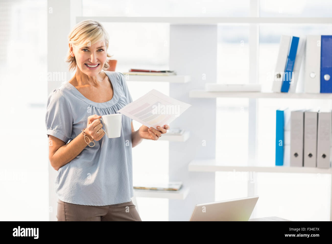 Mature businesswoman holding document hi-res stock photography and ...