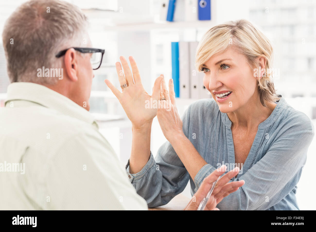 Smiling business team talking together Stock Photo - Alamy