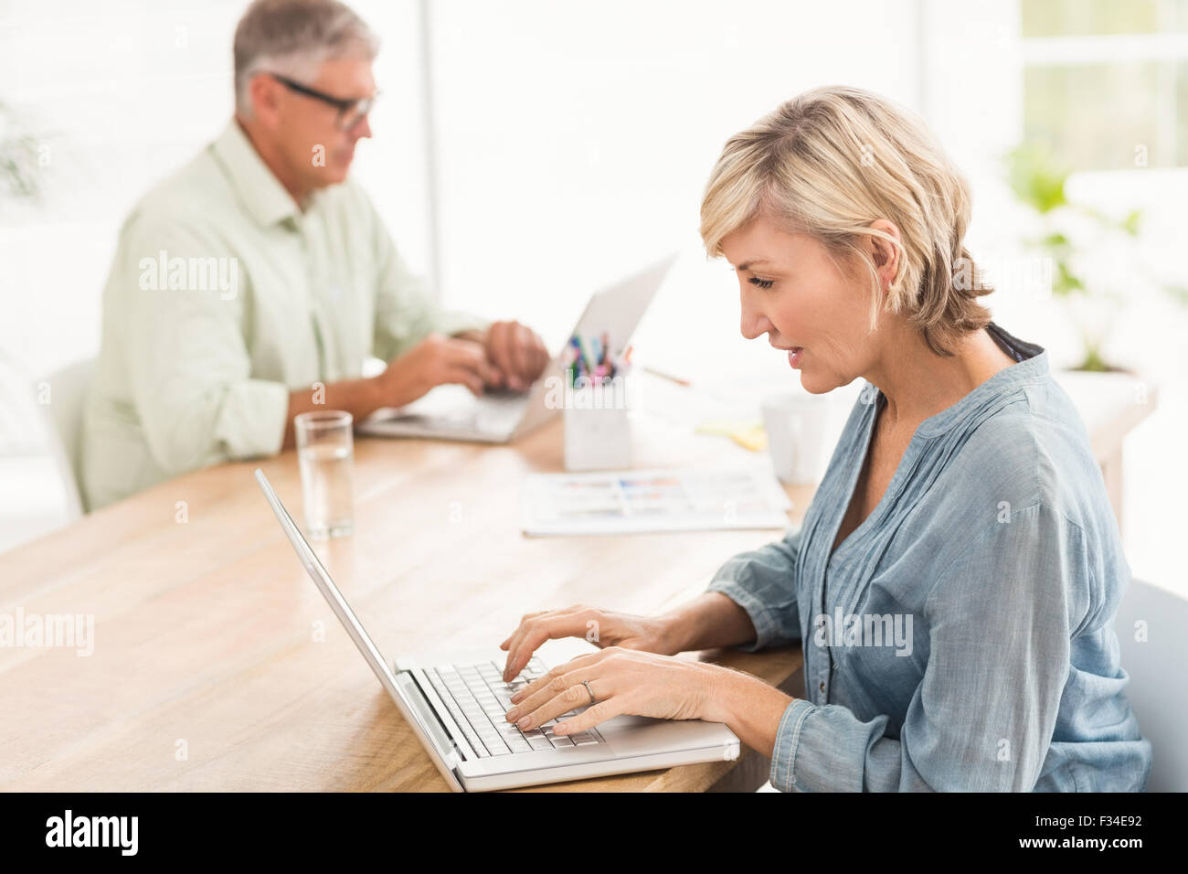 Attentive business team working on laptops Stock Photo - Alamy