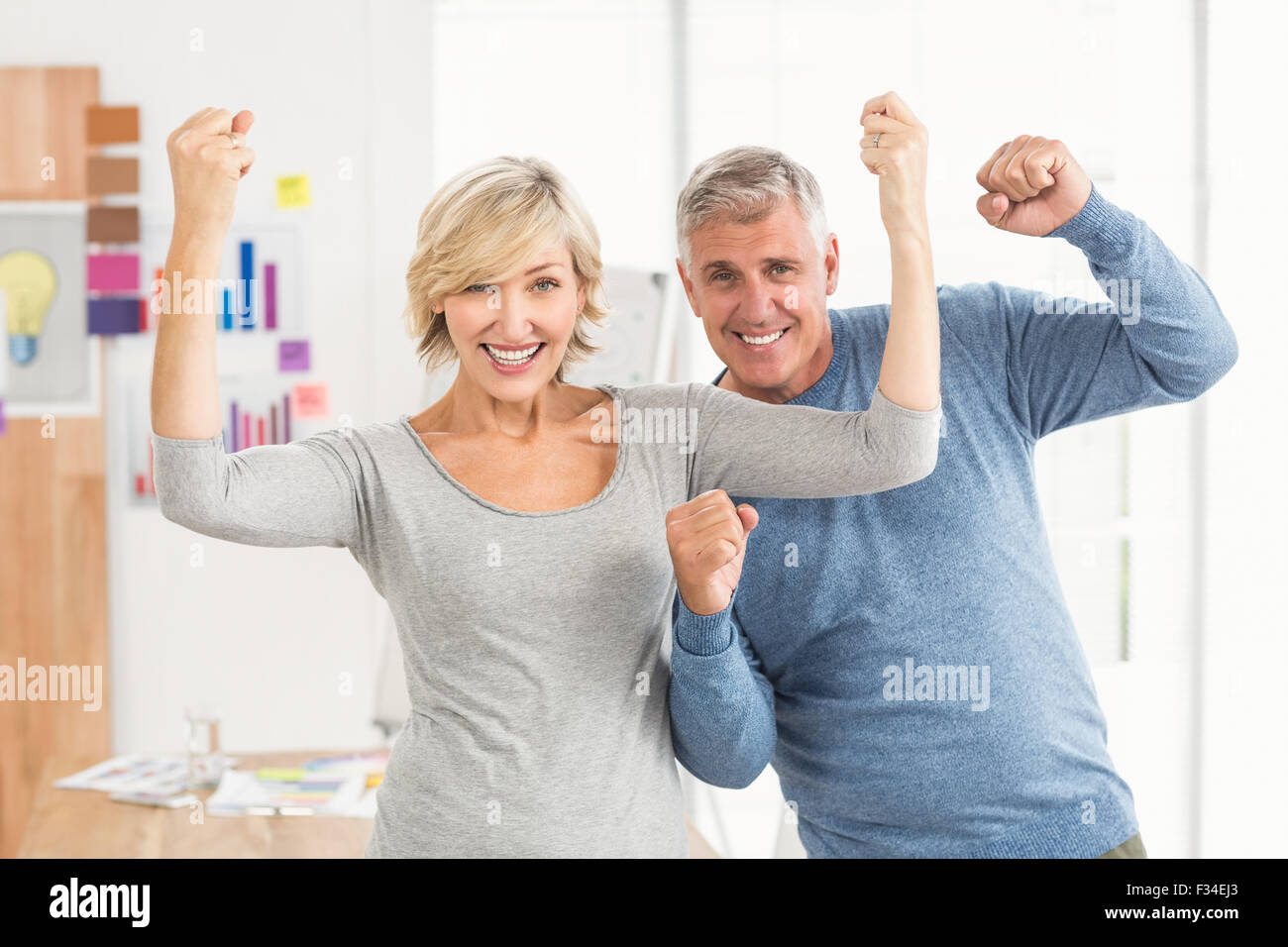 Happy business colleagues gesturing victory Stock Photo - Alamy