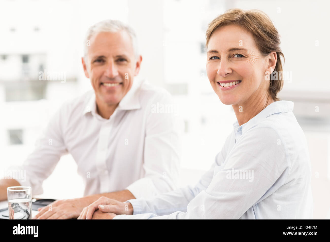 Smiling business partner making an arrangement Stock Photo - Alamy